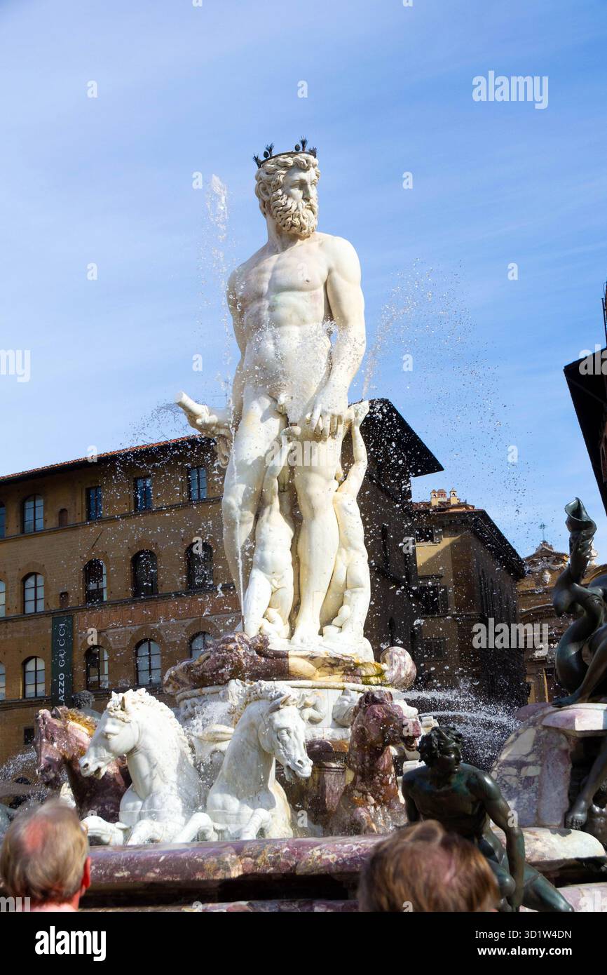 A grand marble statue of Neptune towers over a ornate fountain in a ...