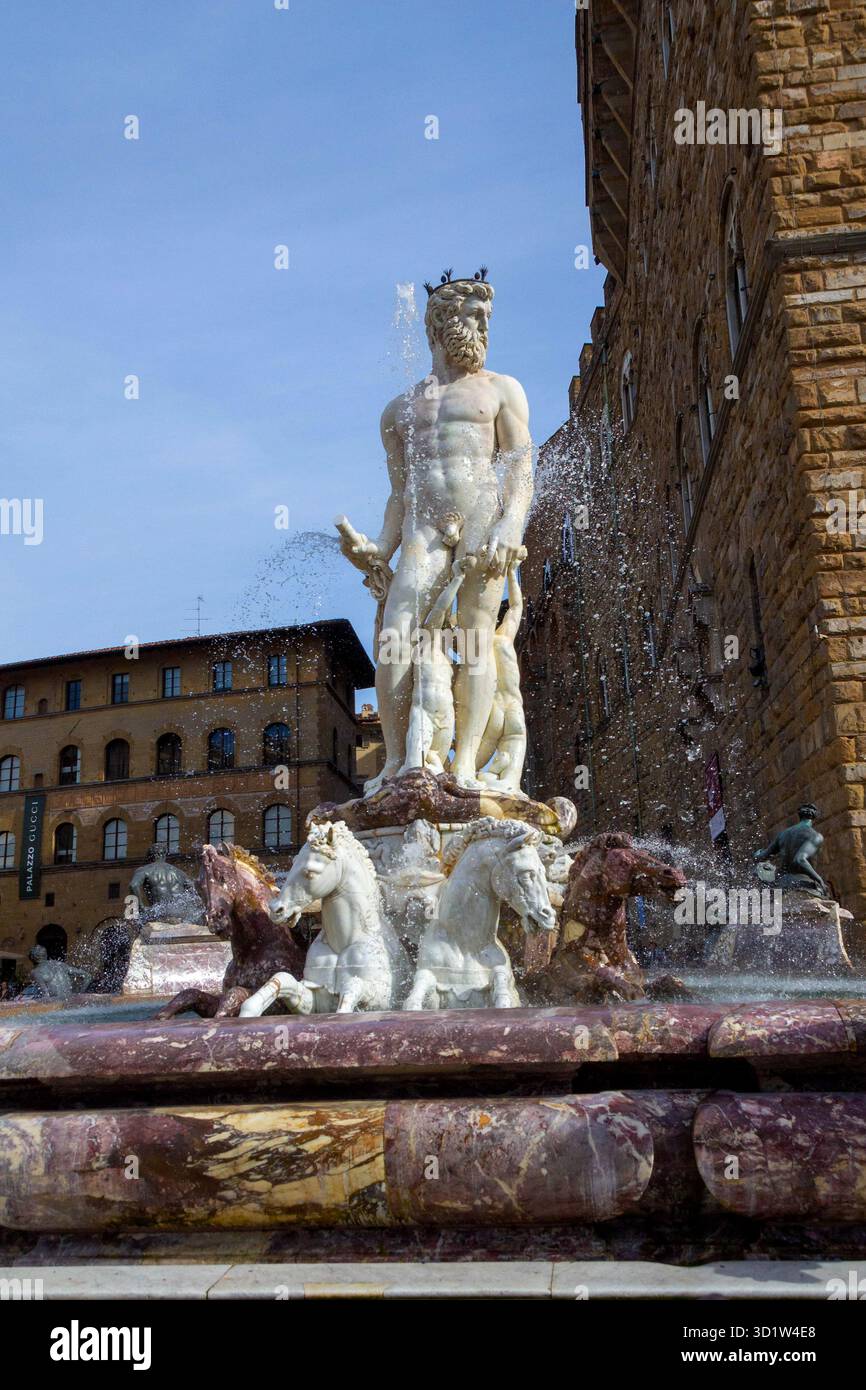 A grand marble statue of Neptune towers over a ornate fountain in a ...
