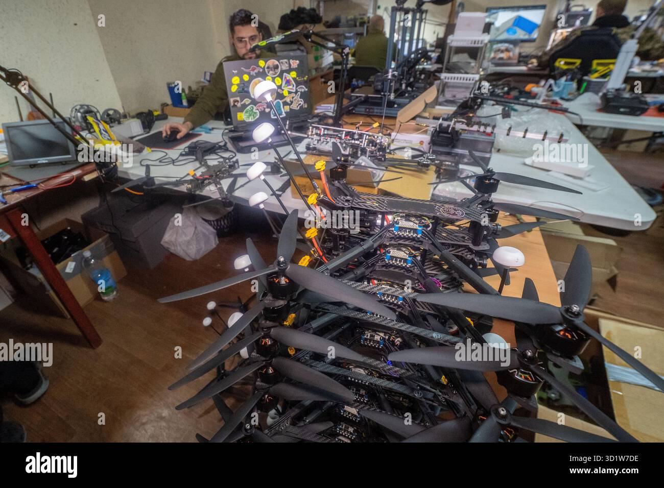 Servicemen of Ukraine's 72nd motorized brigade prepare FPV drones in the workshop near the ...