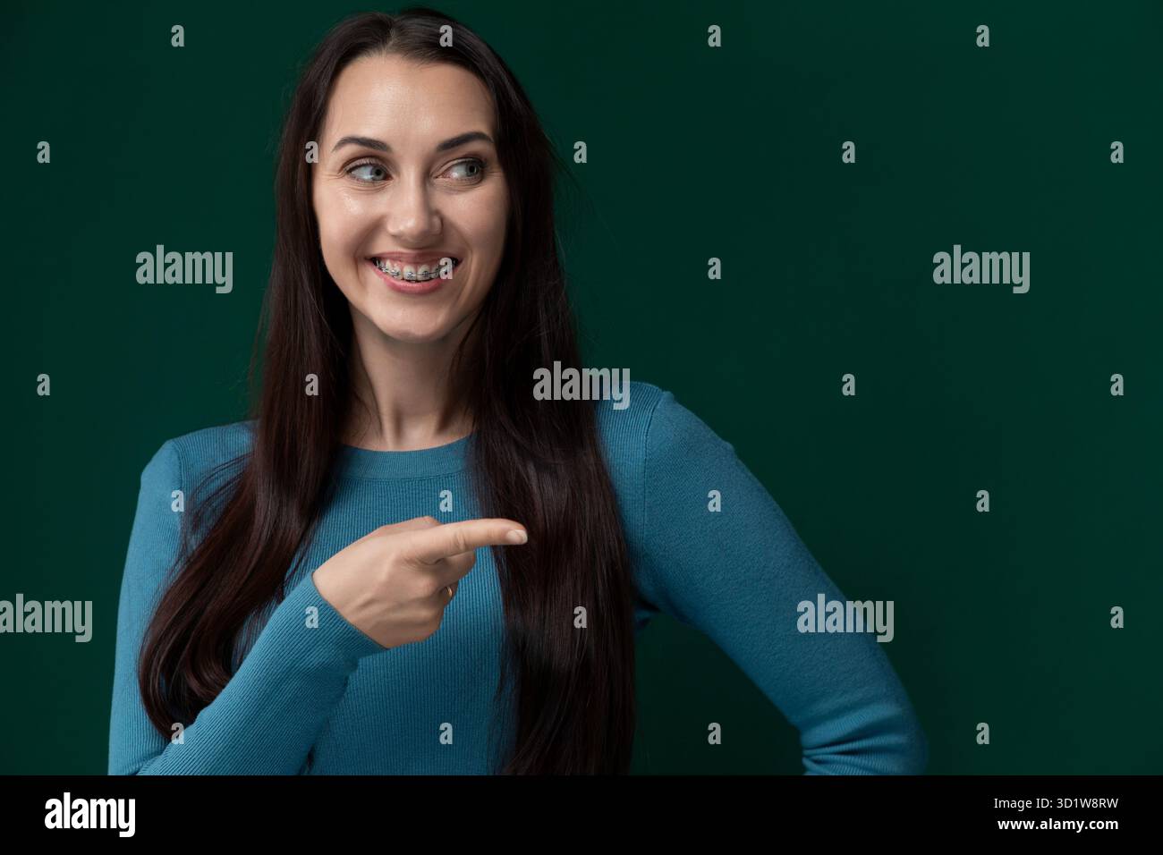 Woman in blue pointing hi-res stock photography and images - Alamy