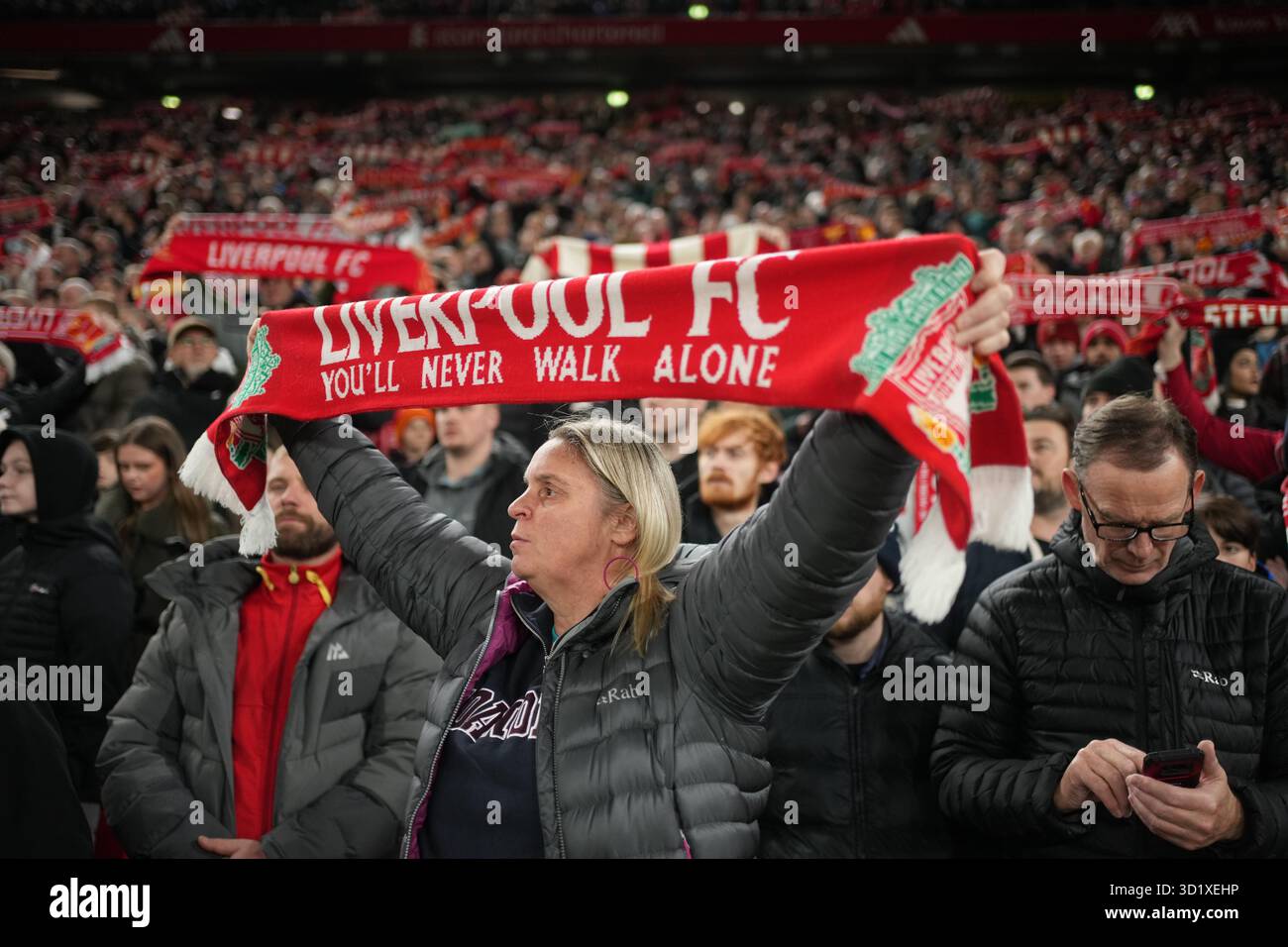 A Liverpool fan holds a scarf during the English League Cup fourth ...