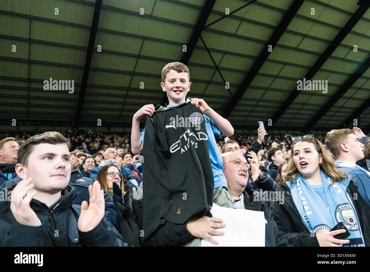 A young Manchester City fan with Phil Foden’s shirt during the Carabao ...