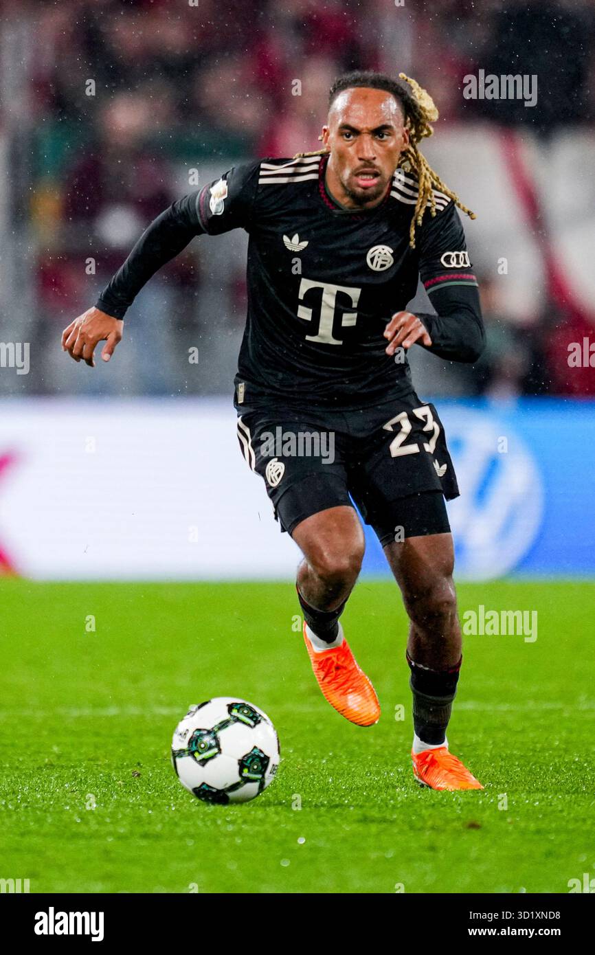 COLOGNE, GERMANY - OCTOBER 29: Sacha Boey of Bayern Munchen dribbles ...