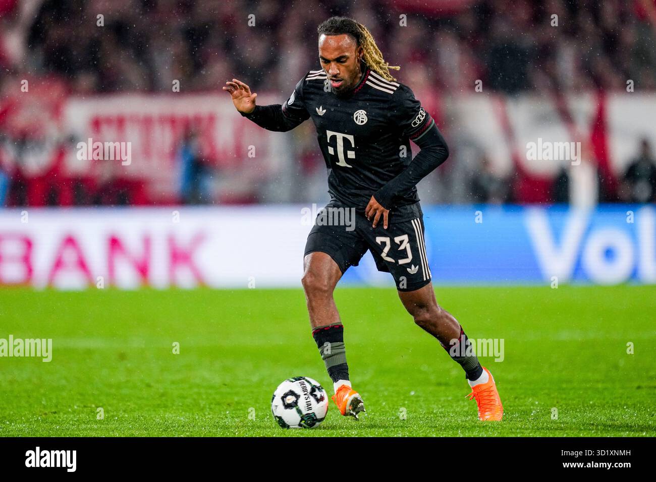 COLOGNE, GERMANY - OCTOBER 29: Sacha Boey of Bayern Munchen dribbles ...