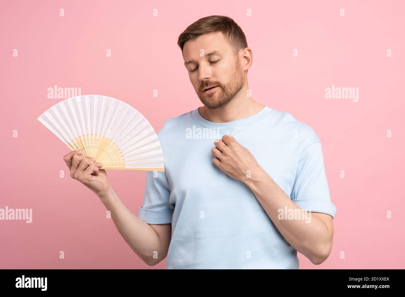 Overheated man waving paper hi-res stock photography and images - Alamy