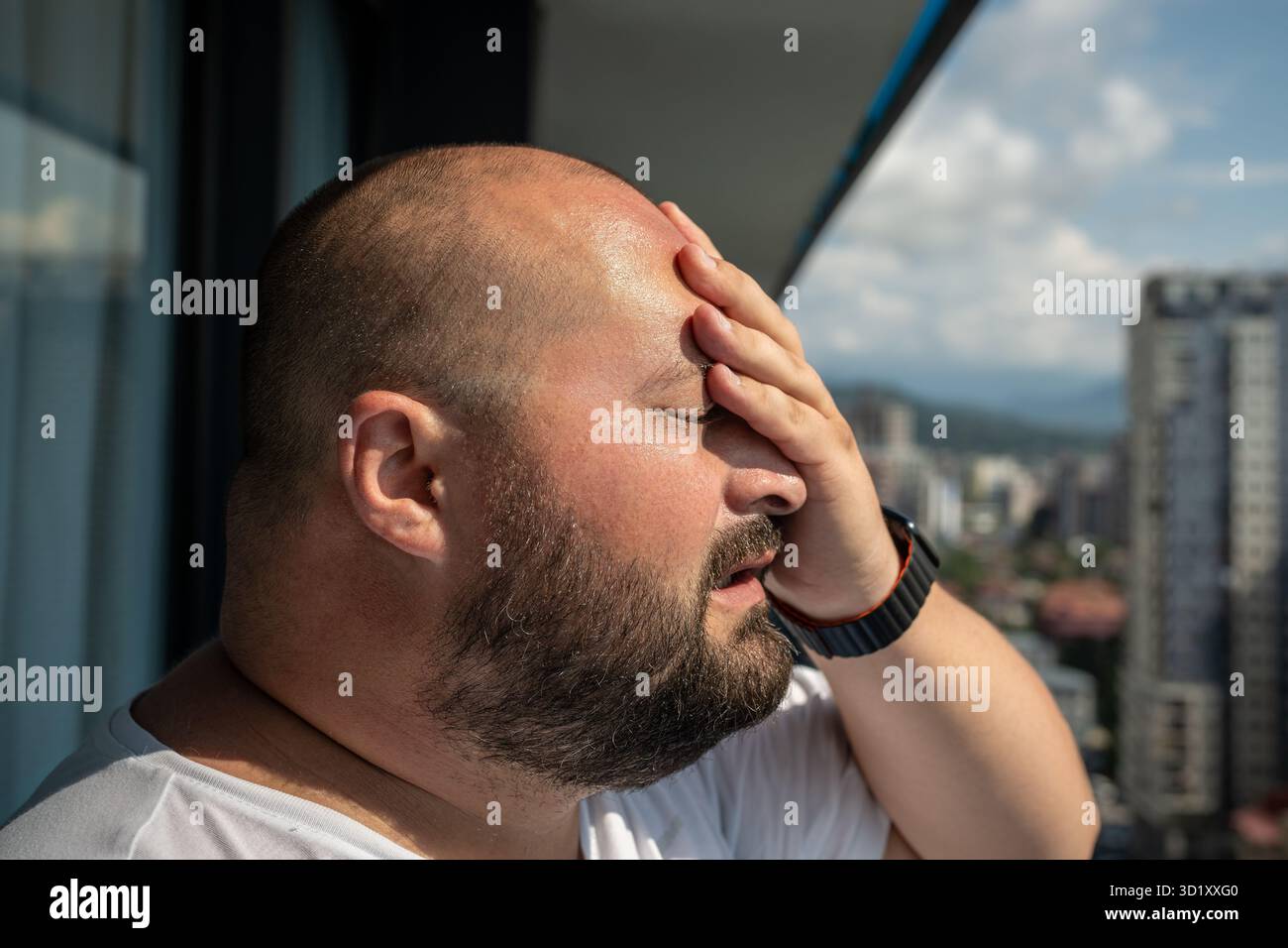Portrait of overweight man has headache touching forehead in heat ...
