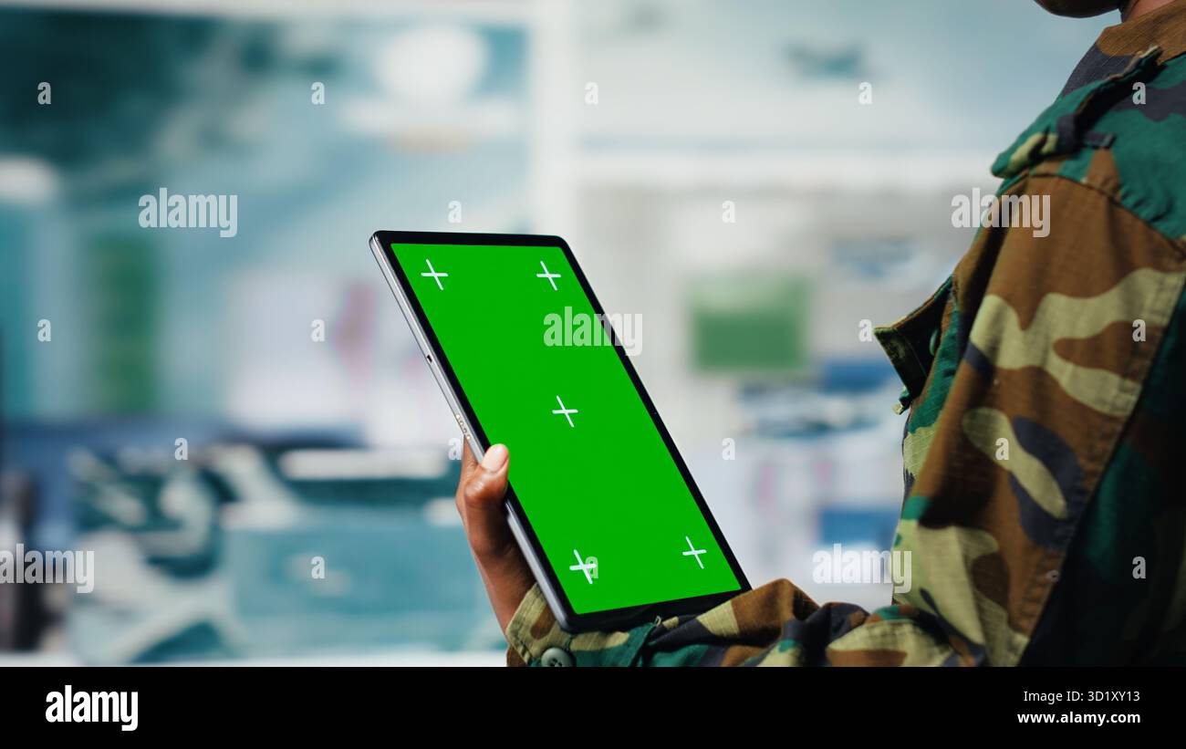 Isolated screen tablet app used by soldier in war room to operate CCTV ...
