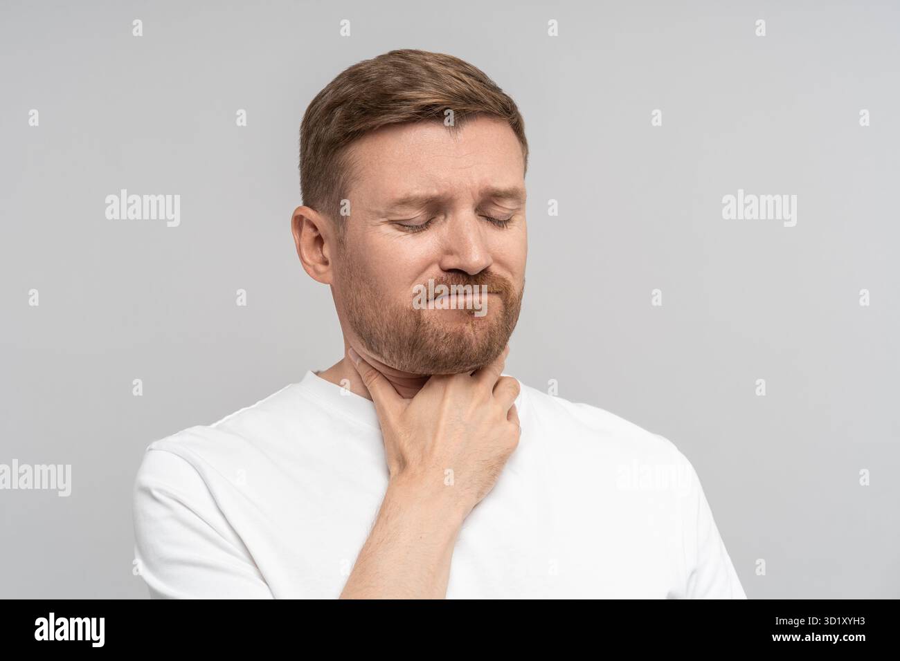 Sick man clutching throat writhing in pain, sore from tonsillitis ...