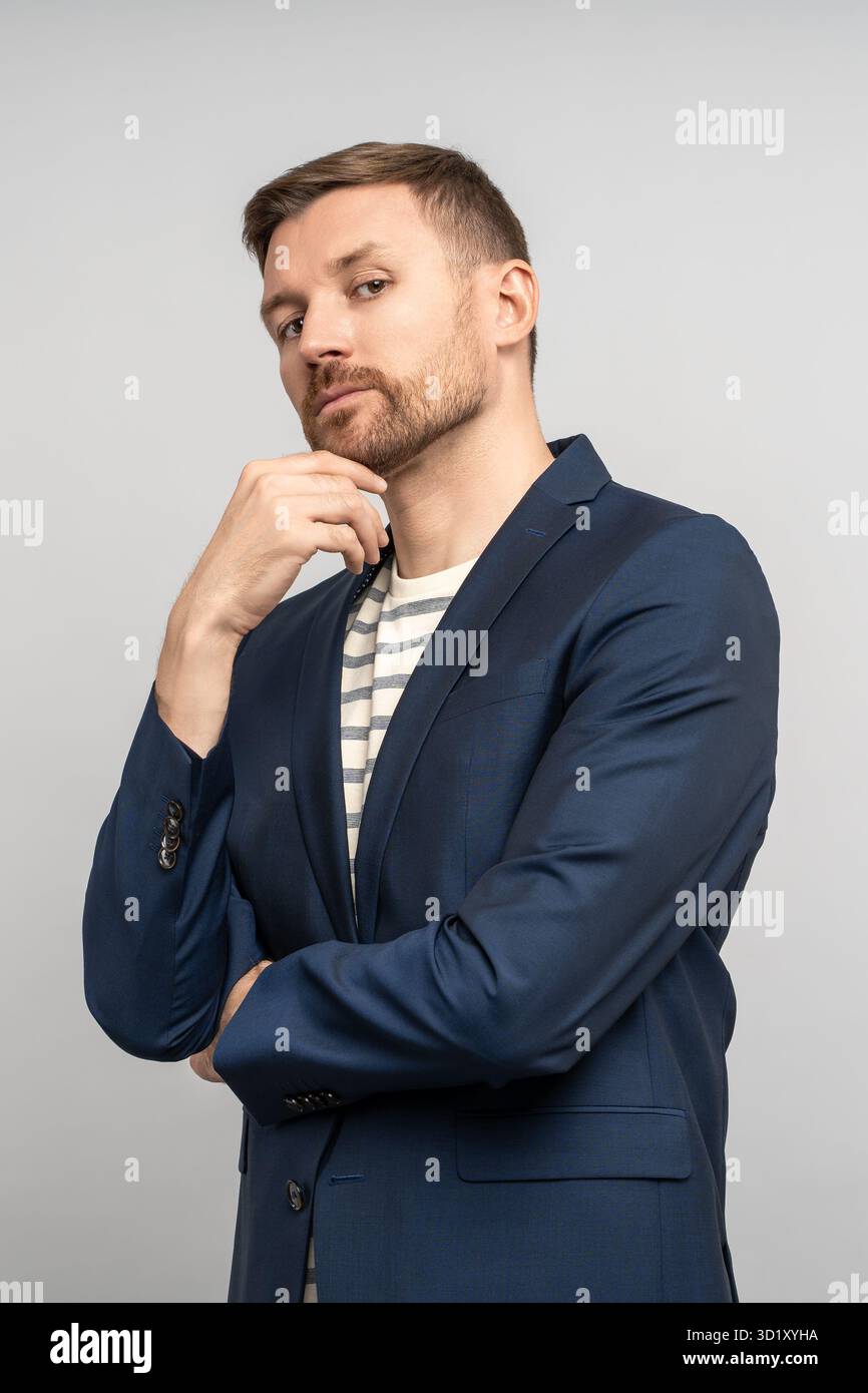 Confident relaxed handsome middle aged man with settled look touching ...