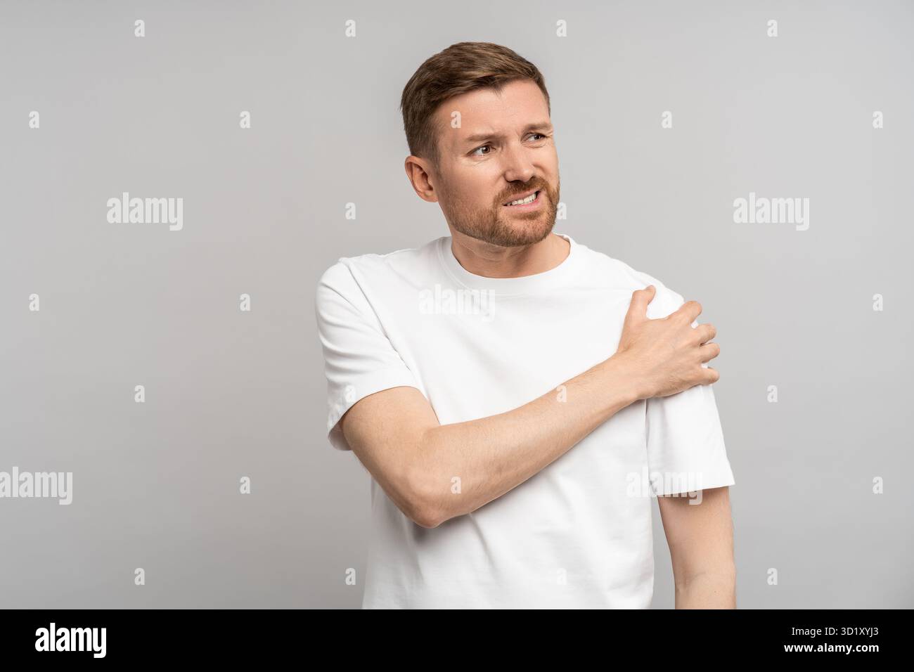 Man touching hand shoulder feeling pain isolated on gray background ...