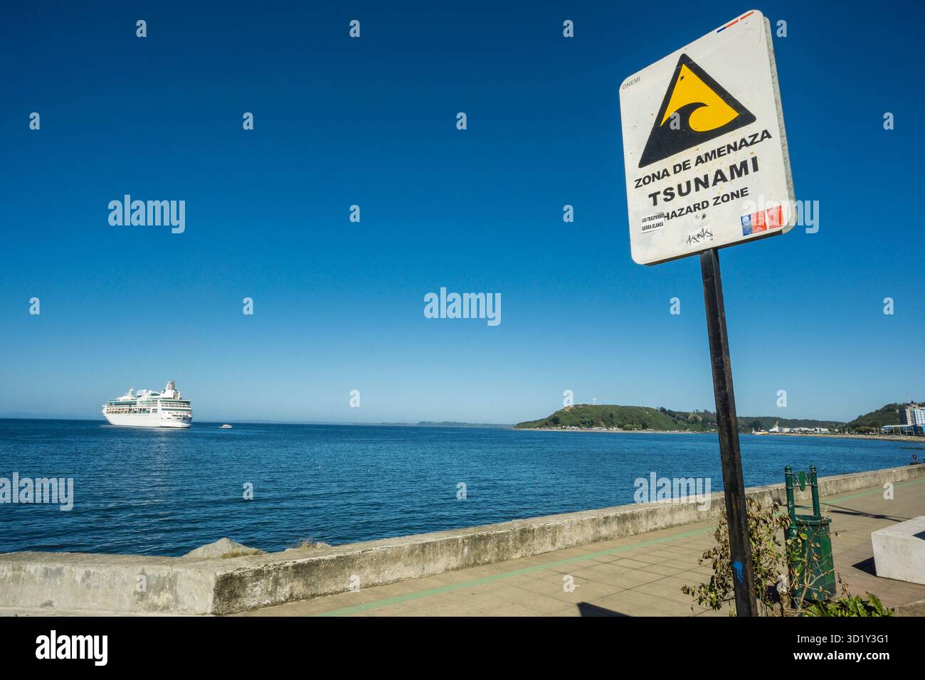 Cruise ship in front of the Costanera and tsunami warning sign, Puerto ...