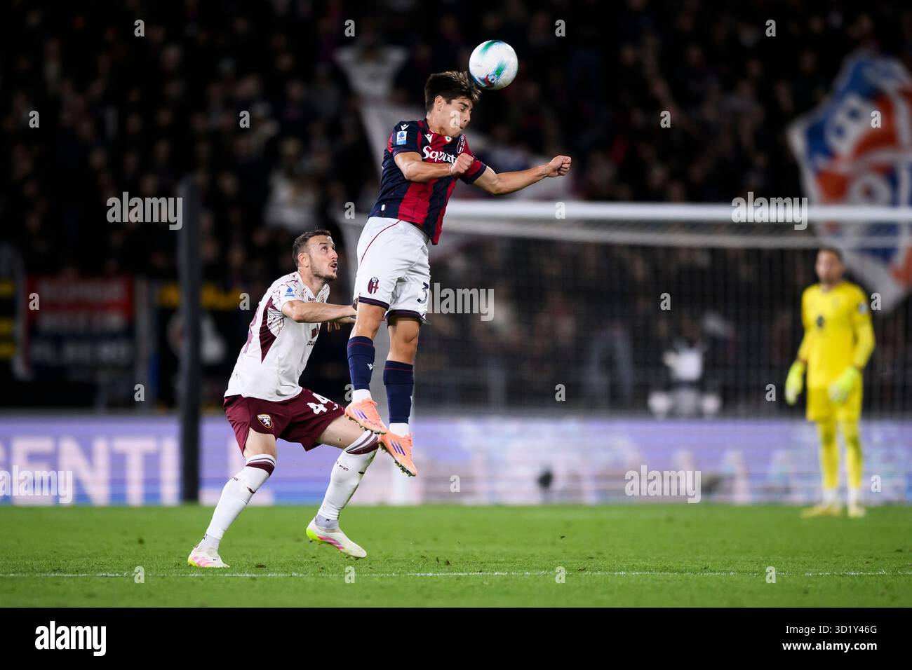 Benjamin Dominguez of Bologna FC competes for a header with Ardian ...