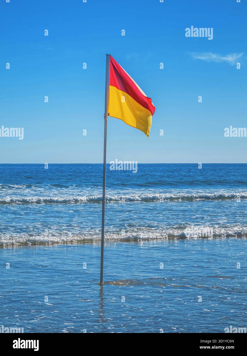 Beachscape with red and yellow flag indicating safe, patrolled beach in ...