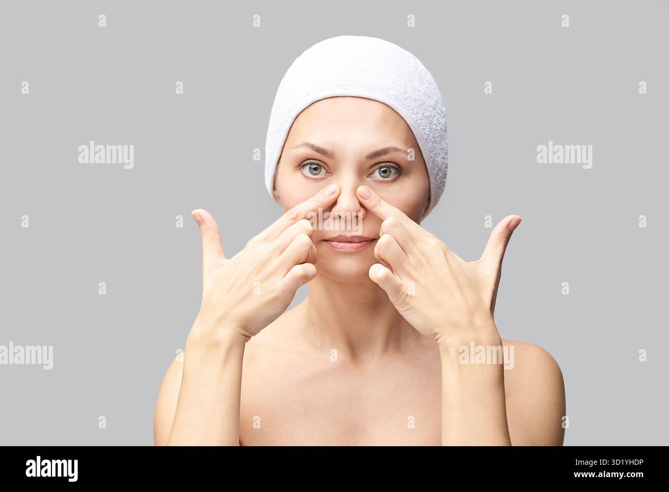 Pretty woman do self face massage. Grey background. Beauty female ...