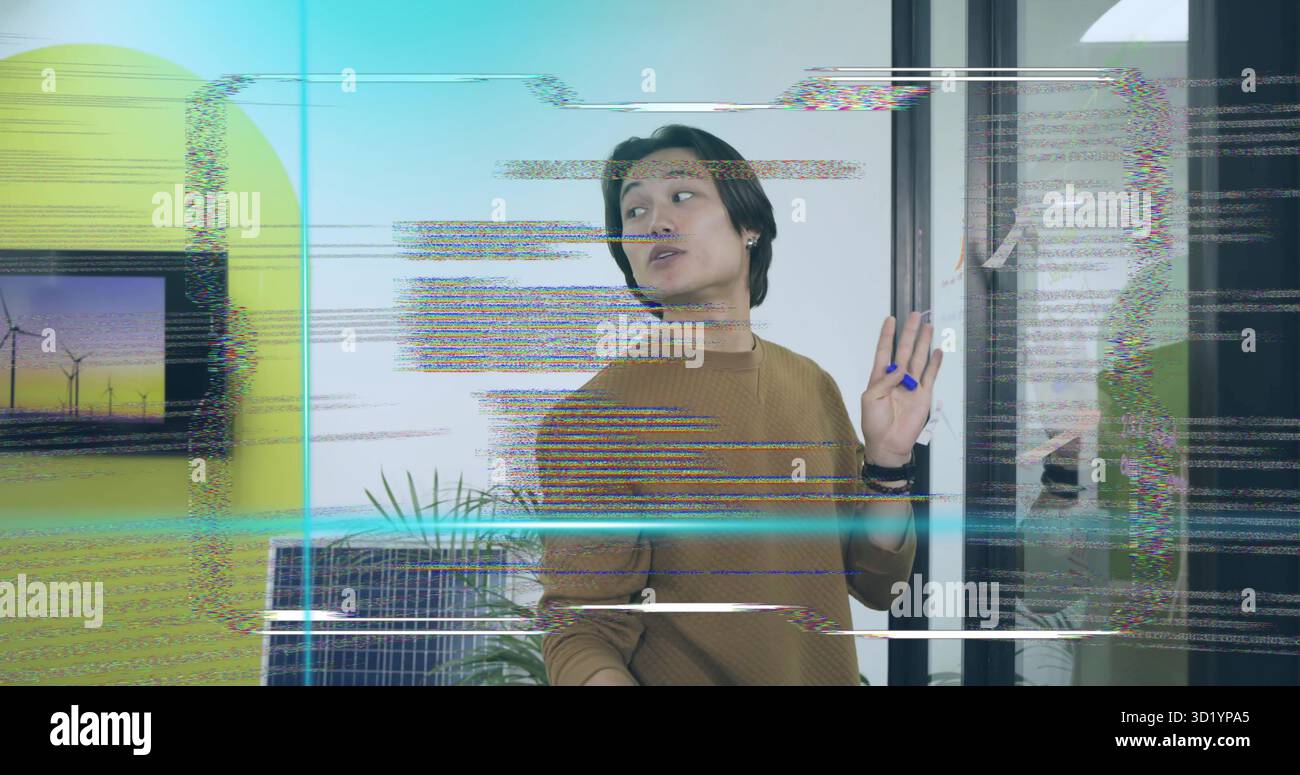 Gesturing Asian man holding blue pen while explaining idea in office ...