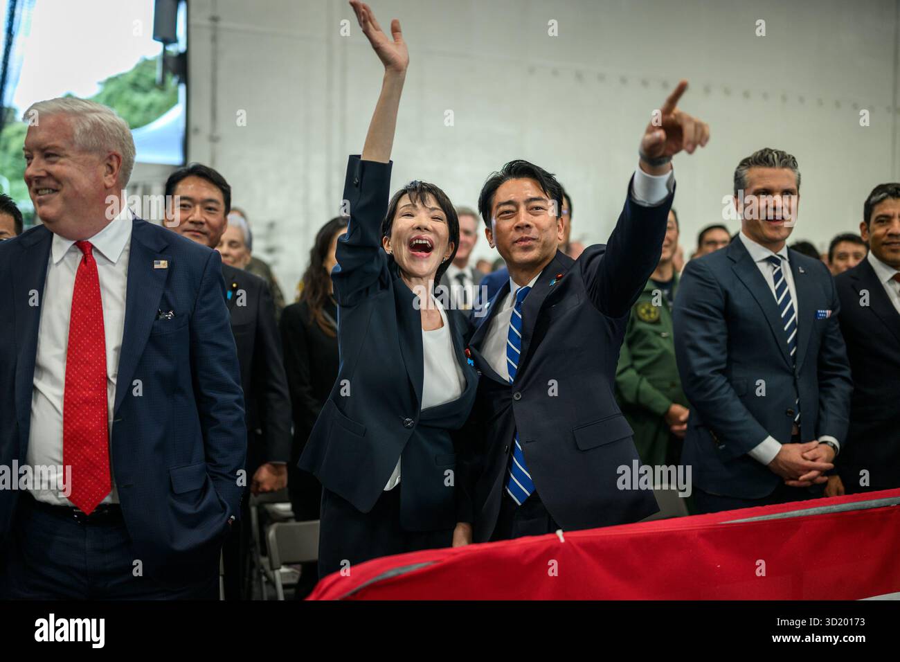 Japanese Prime Minister Sanae Takaichi waves to U.S. Navy sailors ...