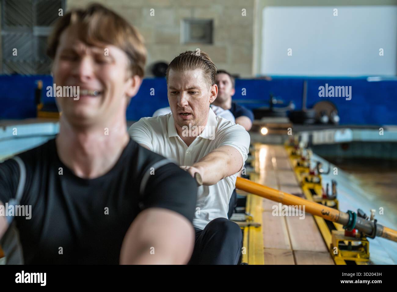 Exhausted male row team push through intense training paddling hard to ...