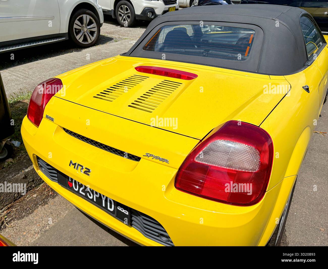 Toyota MR2 Spyder convertible two door sports car, yellow, parked in ...