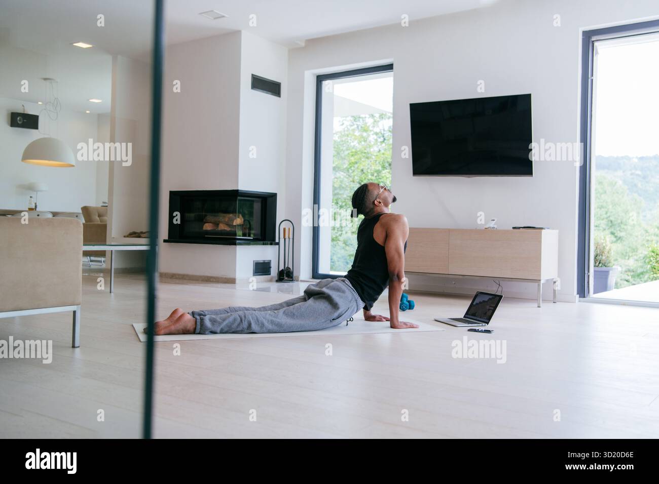 Training At Home. Sporty african american man doing the training while ...