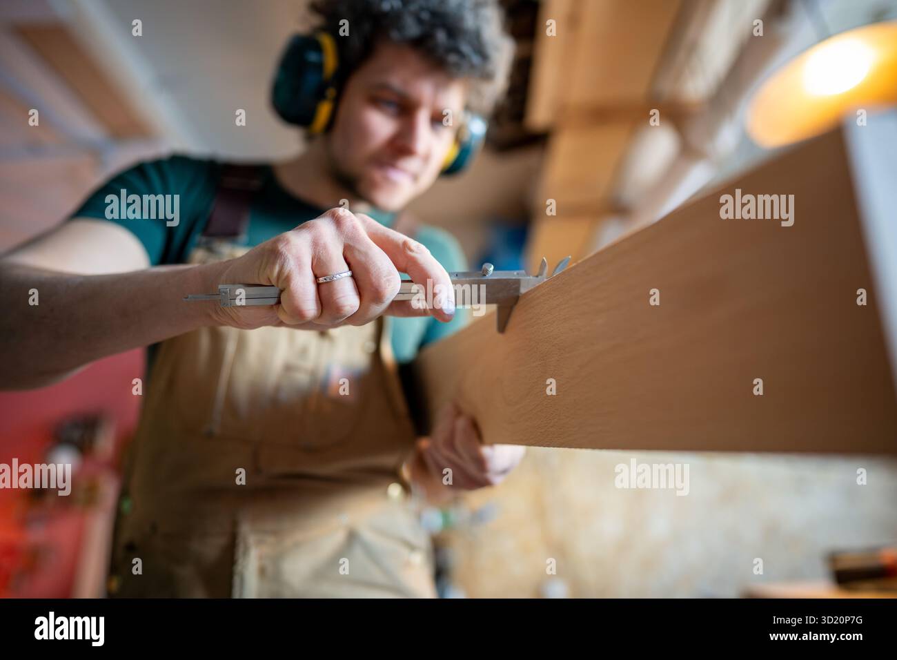 Work with vernier calipers to check wood plank thickness. Close up ...