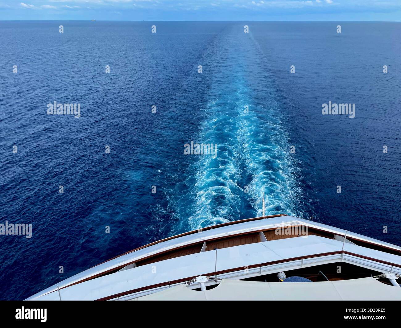A long wake in the ocean trails behind a Disney Cruise Lines passenger ...
