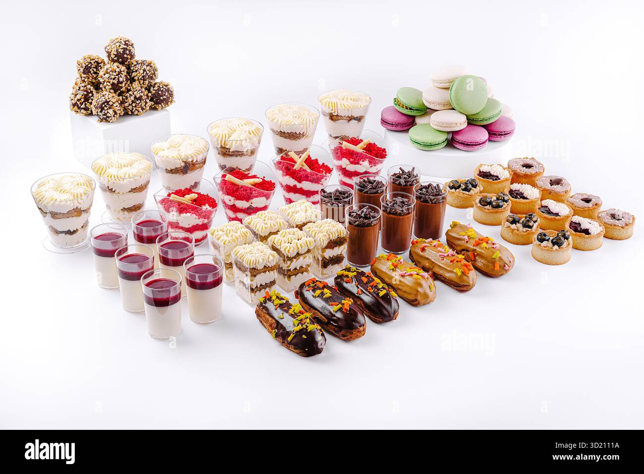A vibrant assortment of desserts showcases layered cups, donuts, and ...