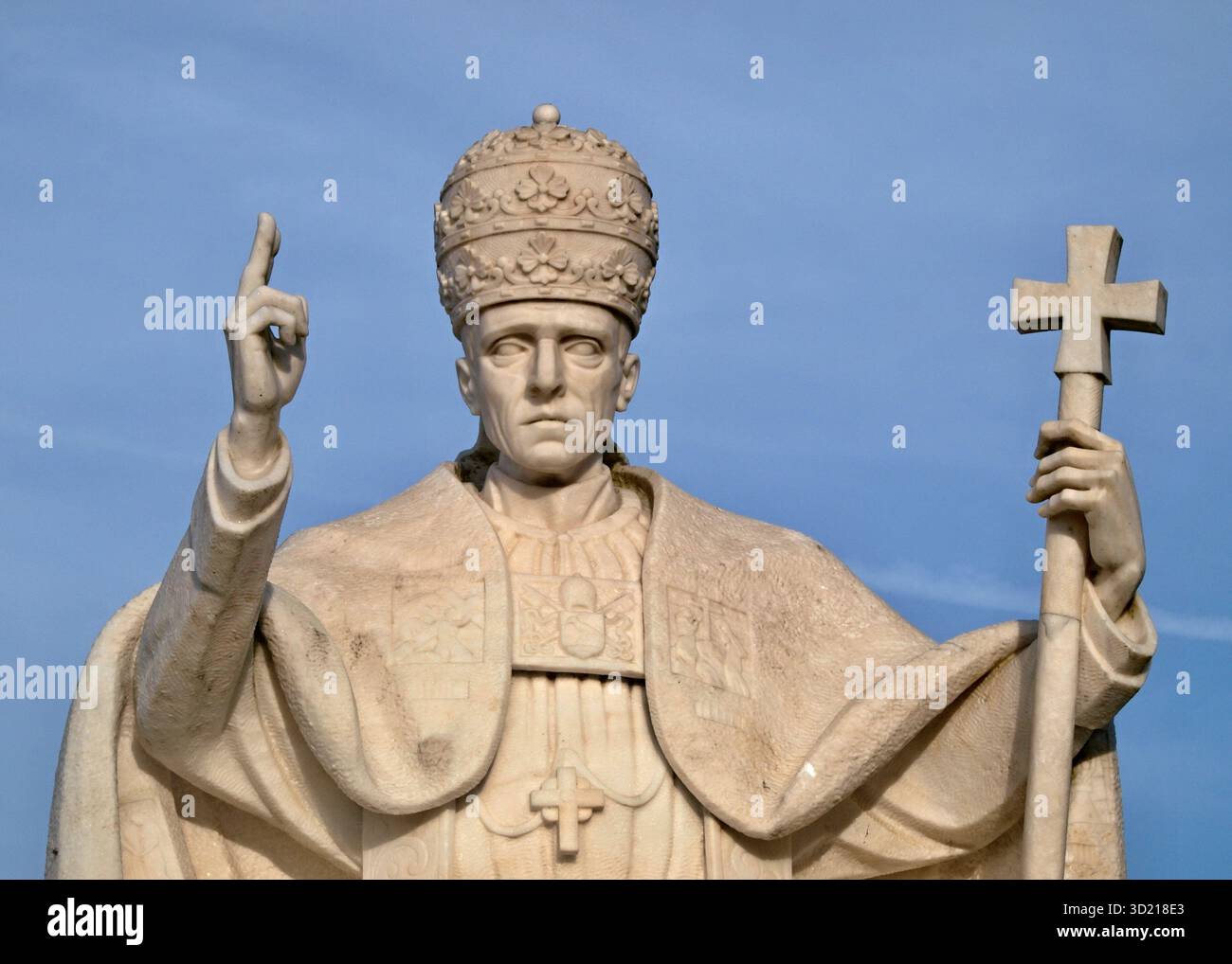 Statue of Pope Pius XI raising his finger and holding a cross Stock ...