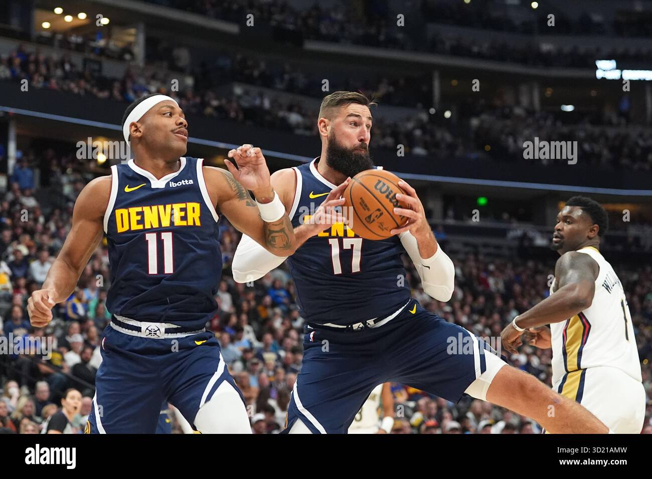 Denver Nuggets center Jonas Valanciunas (17) pulls in a rebound in ...