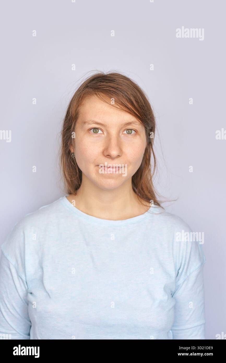 Woman standing against plain hi-res stock photography and images - Alamy