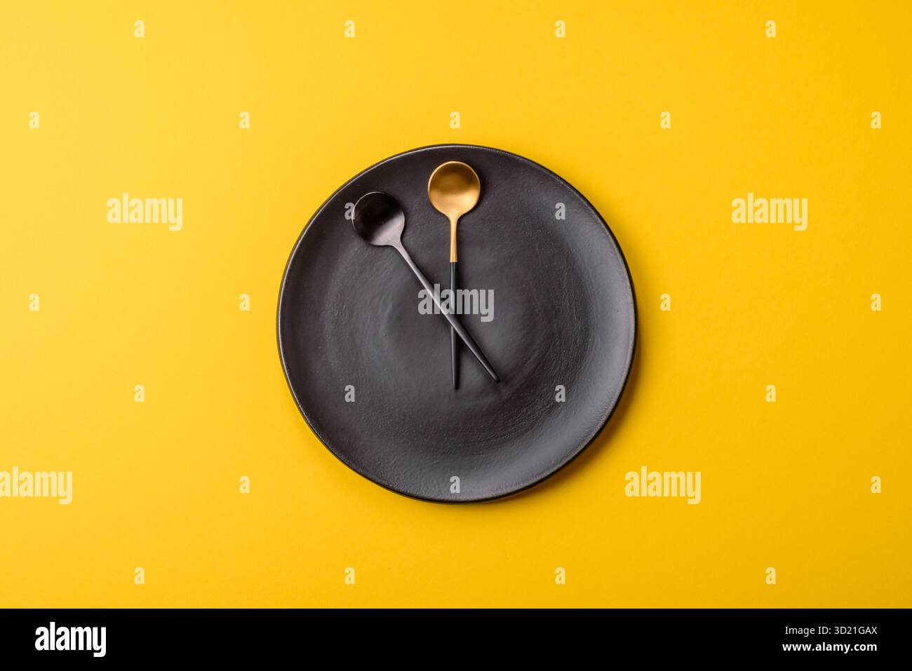 Empty plate with devices in the form of clock hands as a conceptual ...
