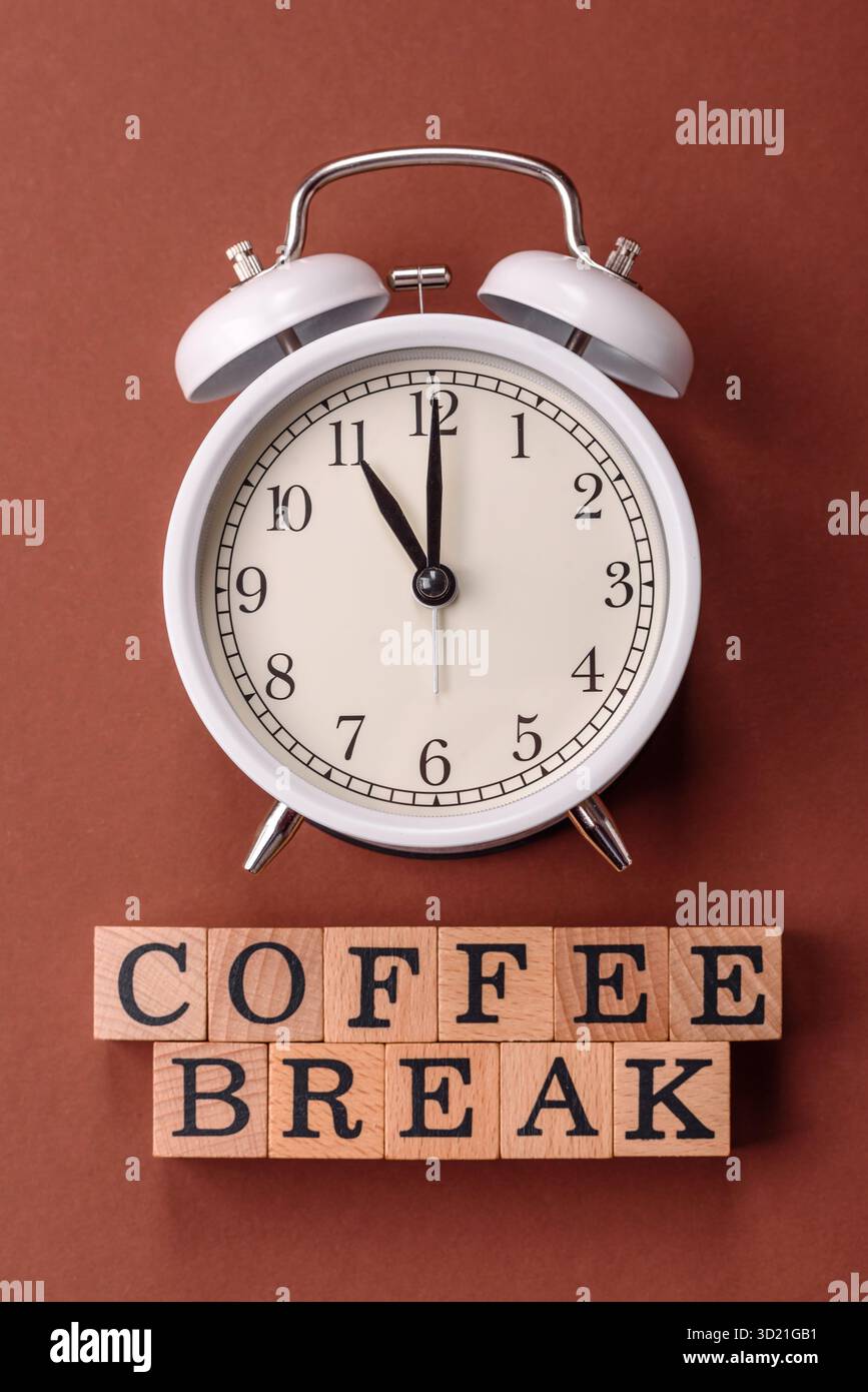 Alarm clock and coffee break lettering as a conceptual backdrop for a ...