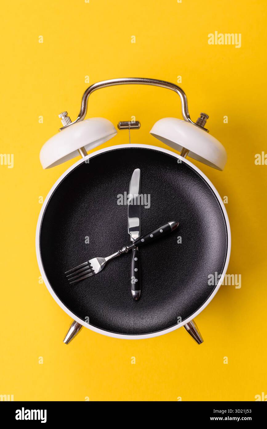 Empty plate with devices in the form of clock hands as a conceptual ...