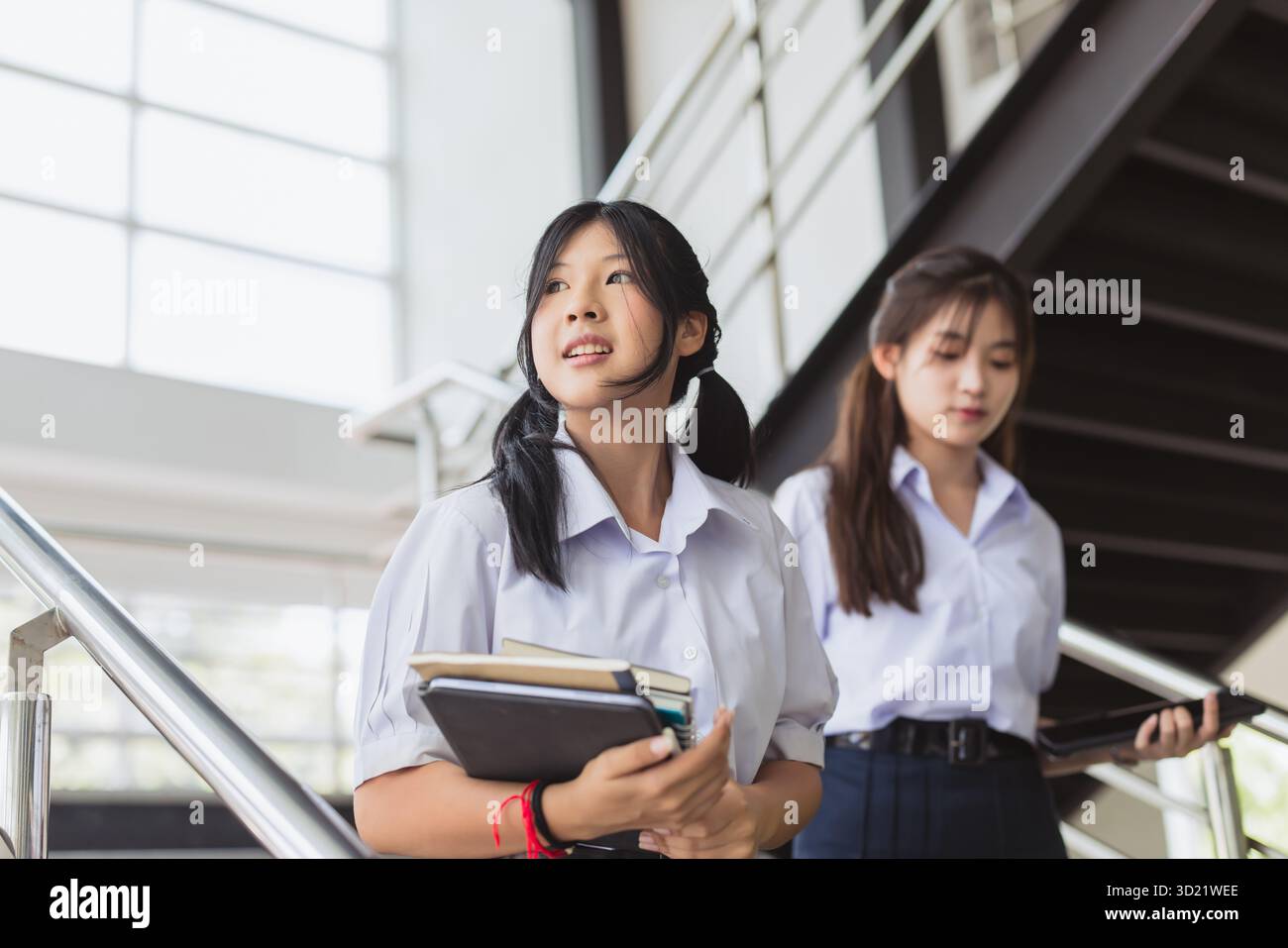 Smart students women teen in uniform with friend in modern school ...