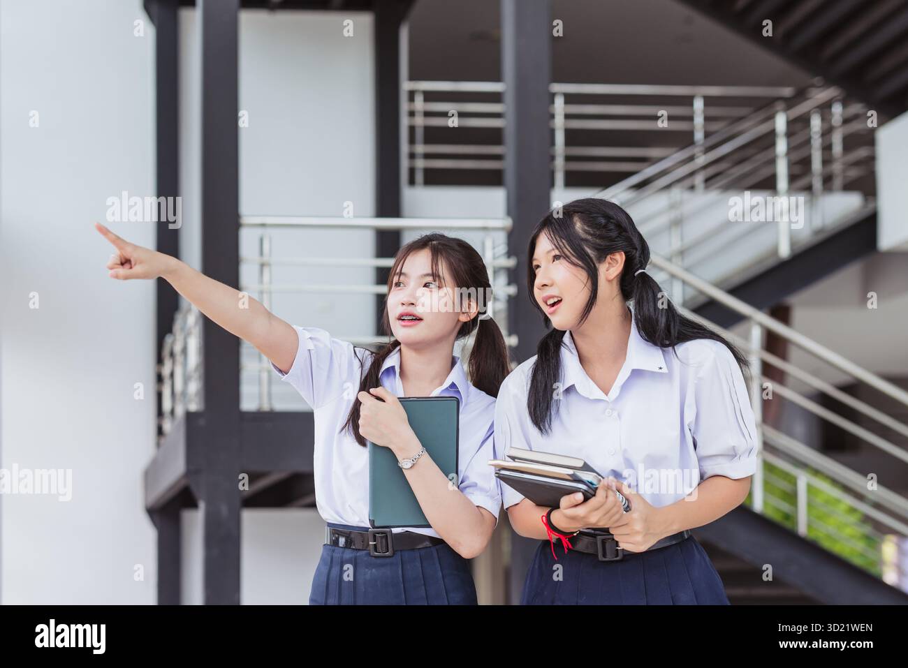 Smart students women teen in uniform with friend in modern school ...