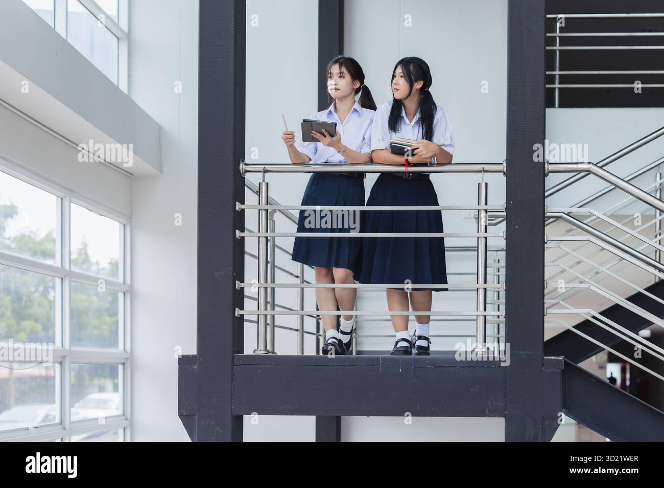 Smart students women teen in uniform standing together at modern school ...