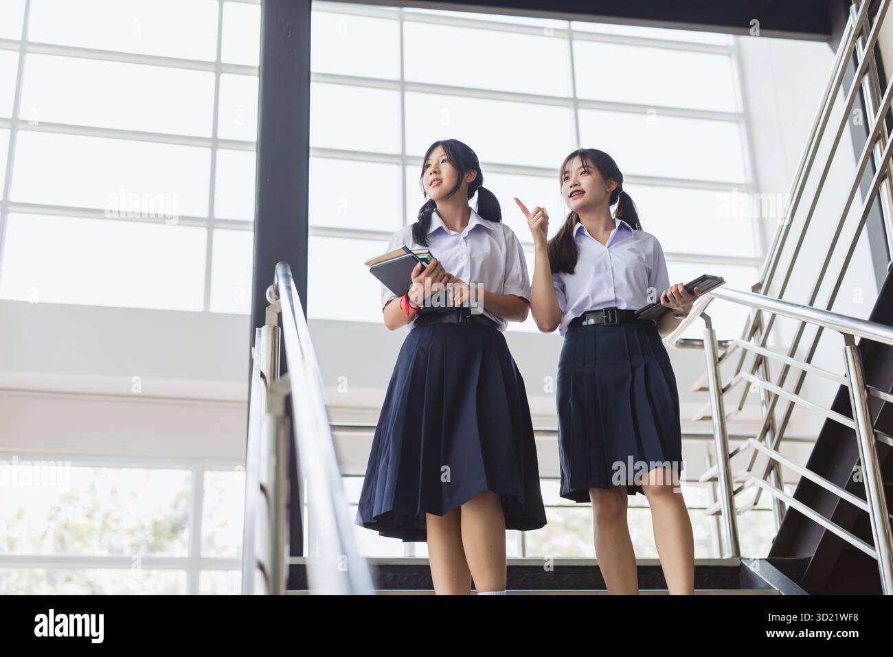 Smart students women teen in uniform with friend in modern school ...