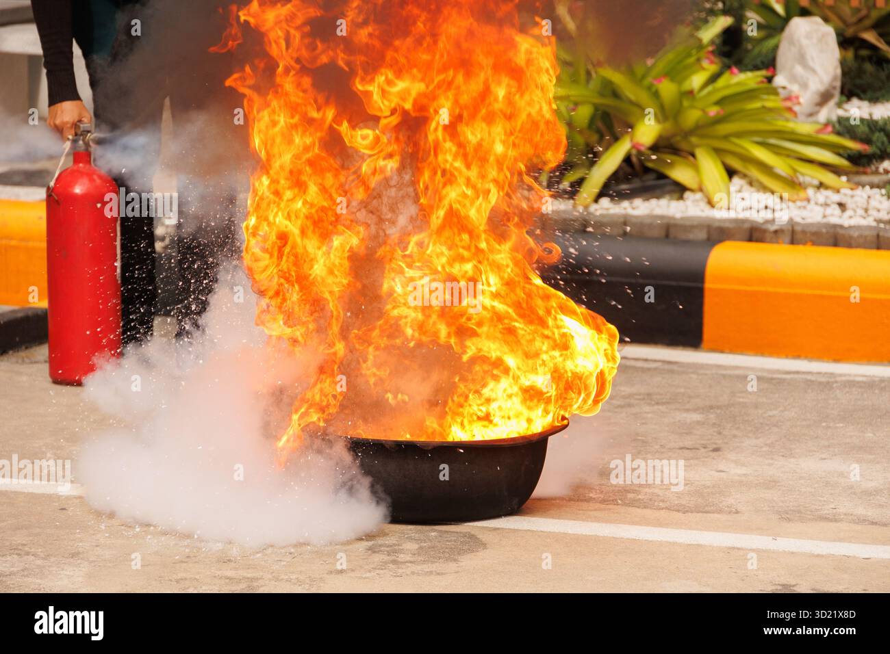 Firefighters use Fire extinguisher spraying chemical liquid fog gas to ...