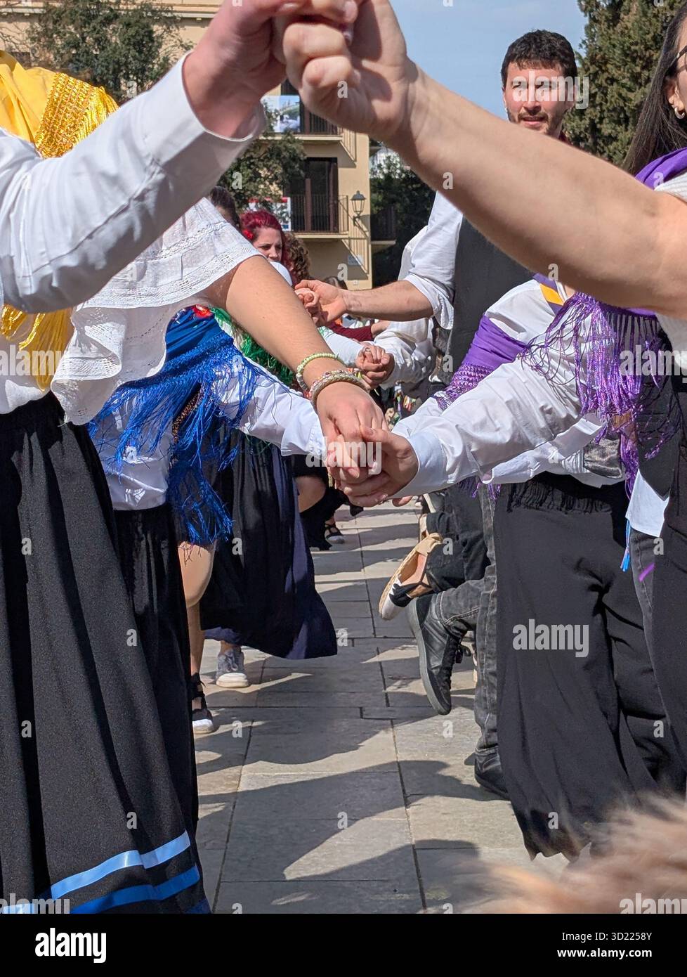 People in traditional costumes holding hands, performing a folk dance ...