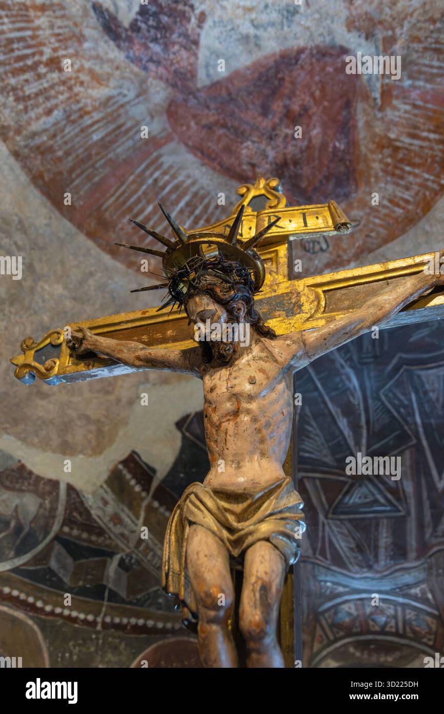 Jesus christ crucified on a golden cross, wearing a crown of thorns ...