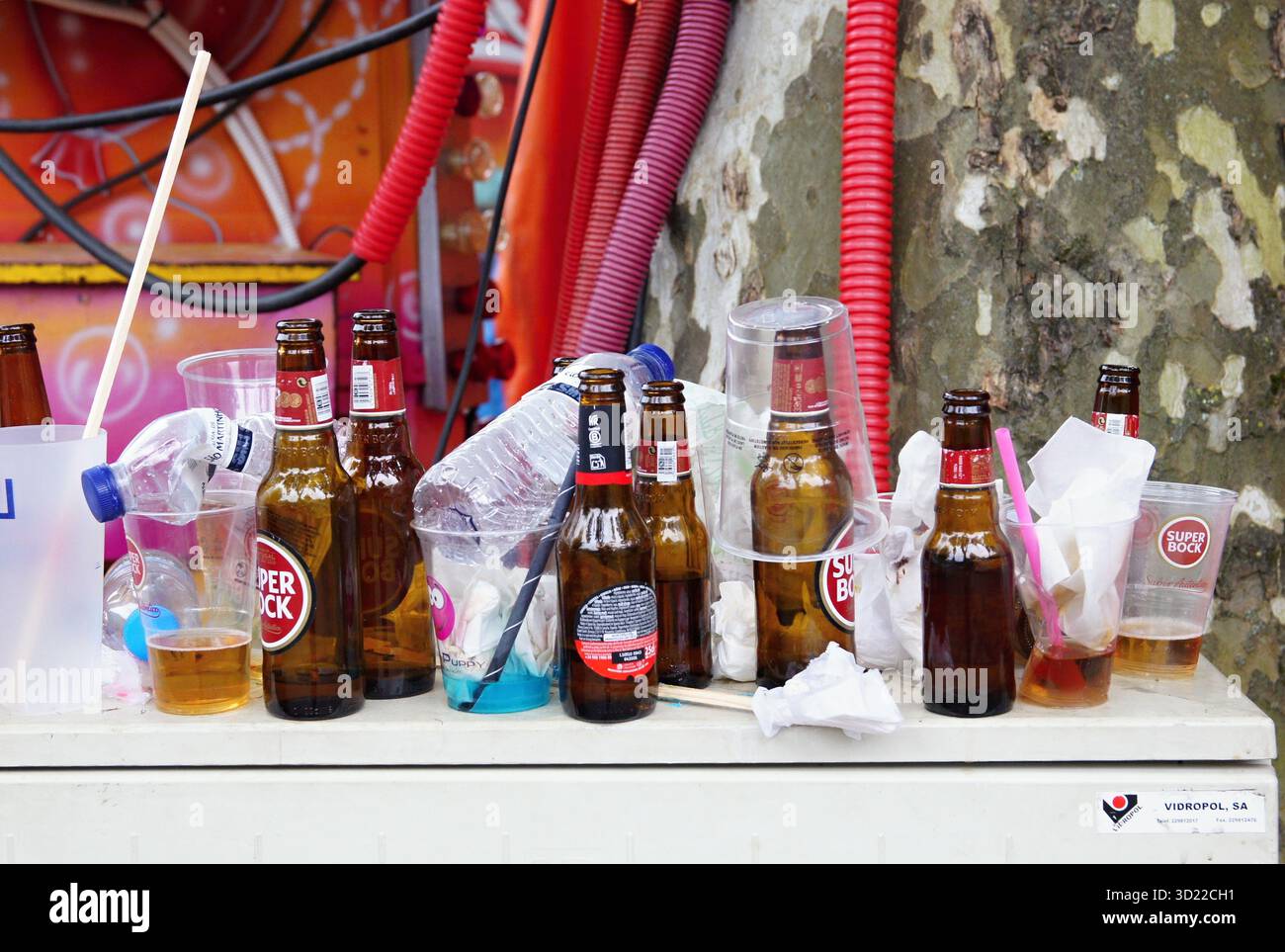 Leftover beer bottles, plastic cups, and crumpled napkins discarded on ...