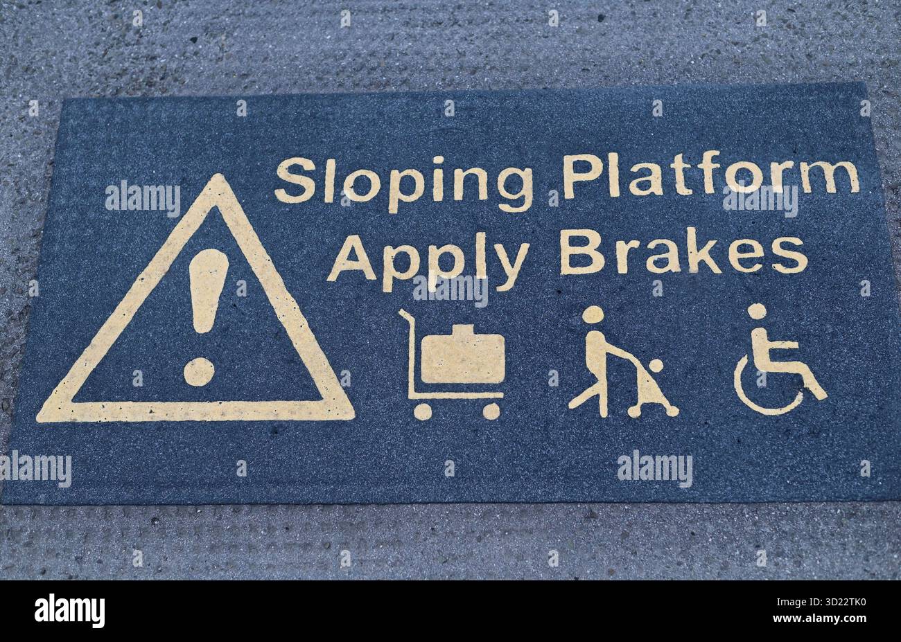 Notice warning about sloping platform at York railway station Stock ...