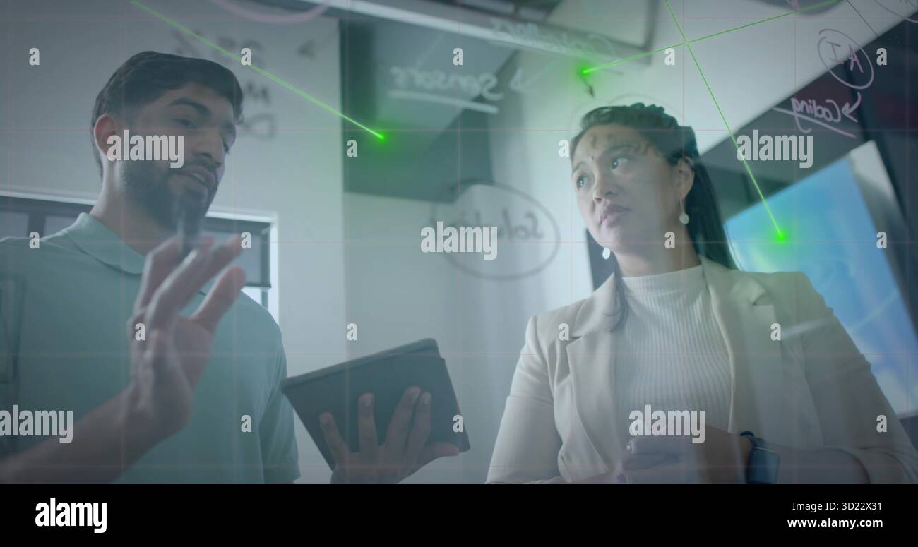 Colleagues in business attire pointing at glass board collaborating in ...