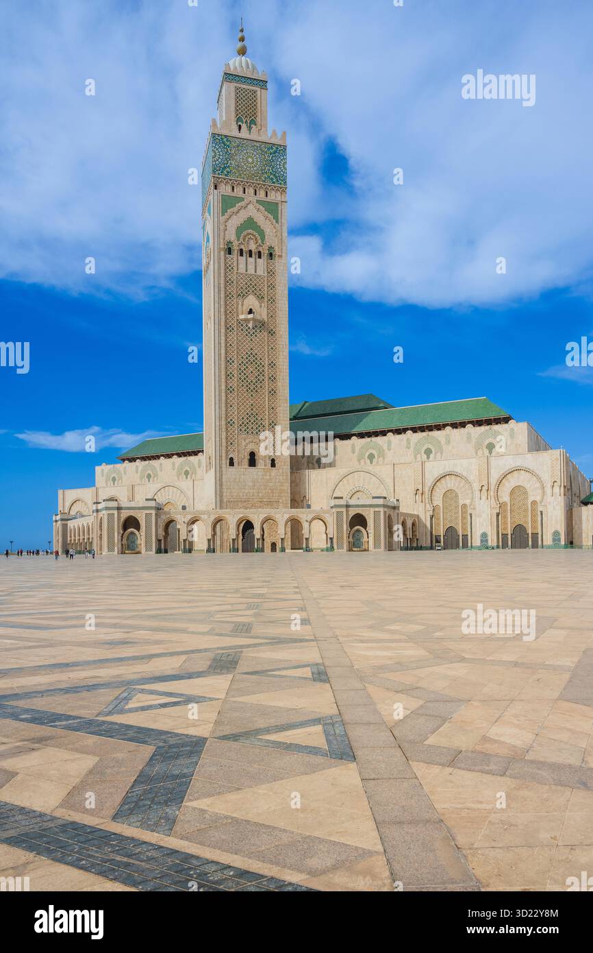Majestic mosque with tall minaret against a bright blue sky and ...