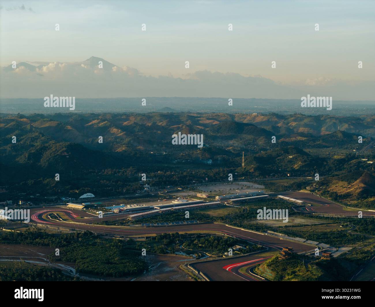 Aerial view of a winding mountain racetrack surrounded by lush green ...