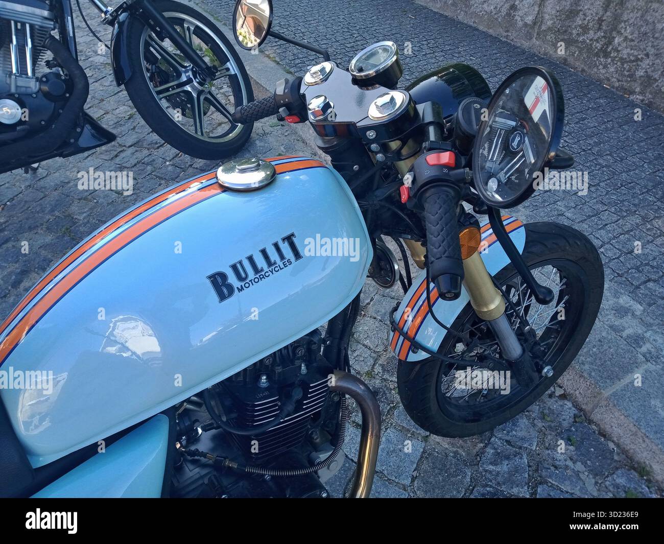 Close-up of a light blue and orange Bullit motorcycle parked on a ...