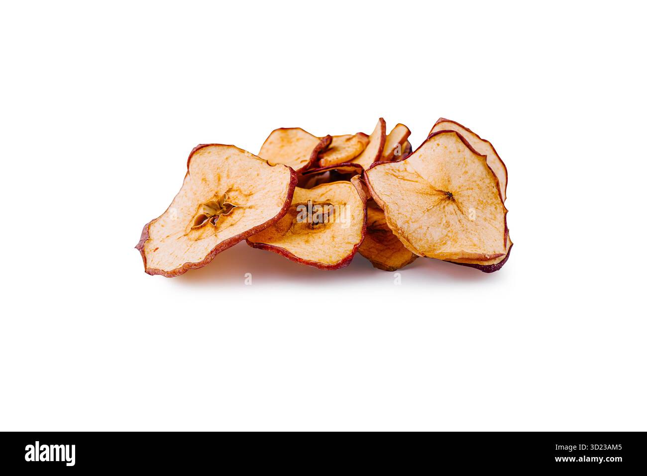 Dried apple slices piled on a white surface highlighting their texture ...