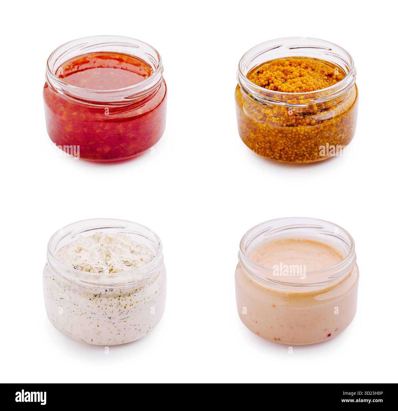Four glass jars filled with different sauces and dips showcase a ...