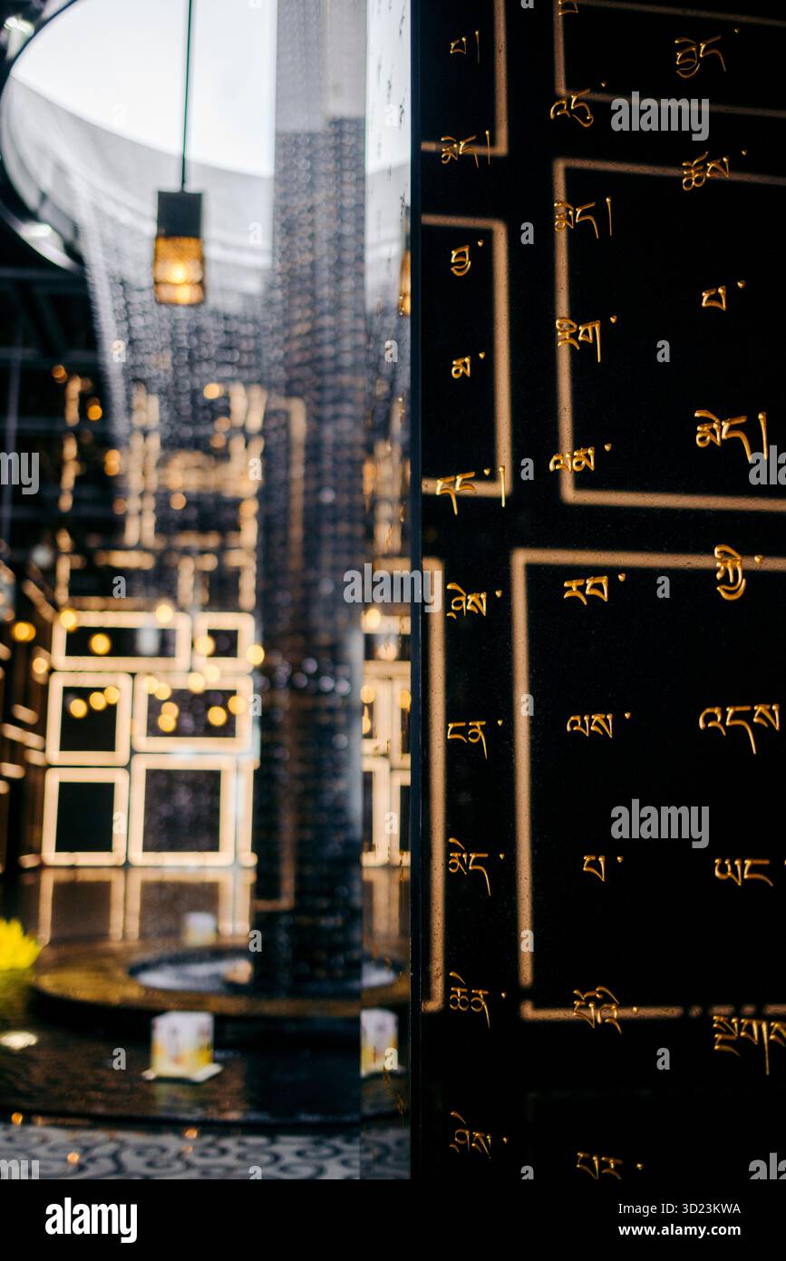 Reflective black surface with gold scripts in a modern architectural ...