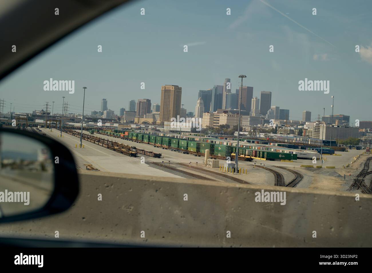 View of a detailed urban skyline with freight containers and parked ...