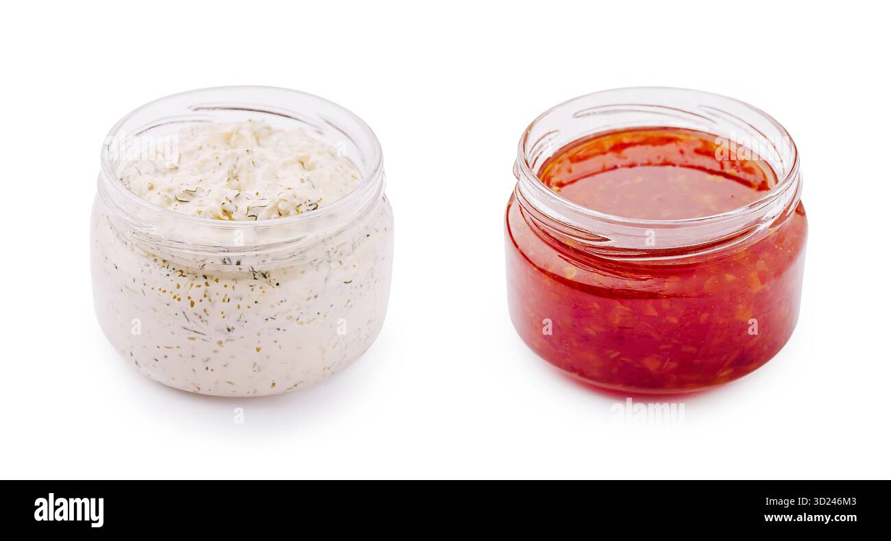 Two glass jars filled with distinct sauces are presented on a clean ...